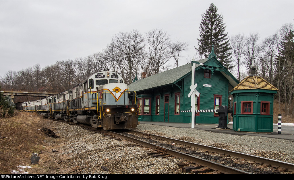 PT -98 rolling downgrade past the ex-Lackawanna passenger station at Cresco